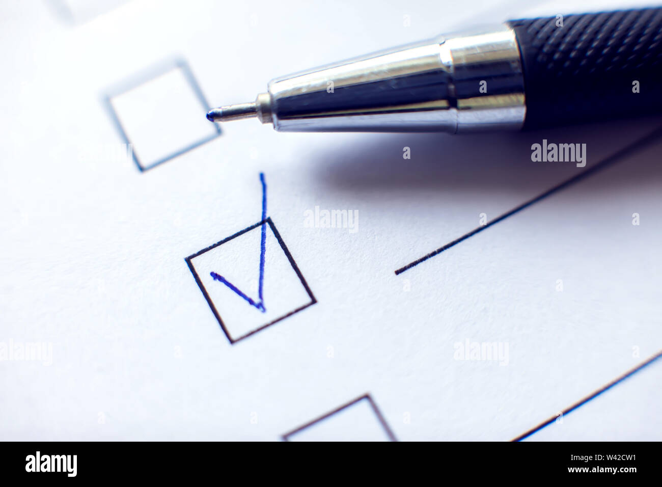 Checklist with a pen on white paper. Checkbox concept Stock Photo - Alamy