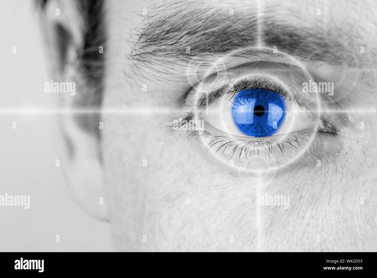 Vision concept with a greyscale image of a mans eye with a crosshair ...