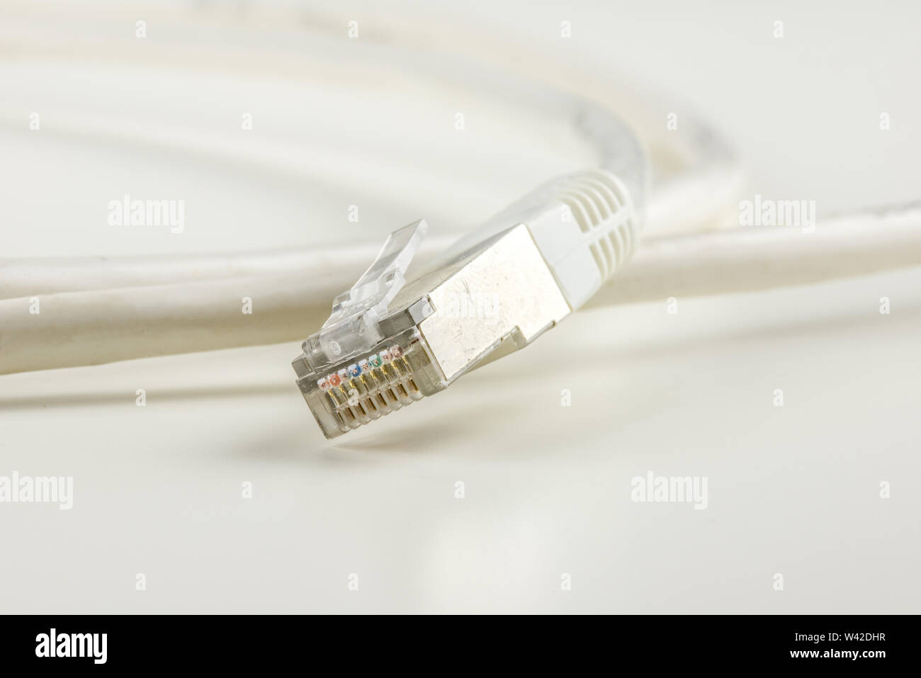 View of the pins of a white network cable for connecting computer to ...