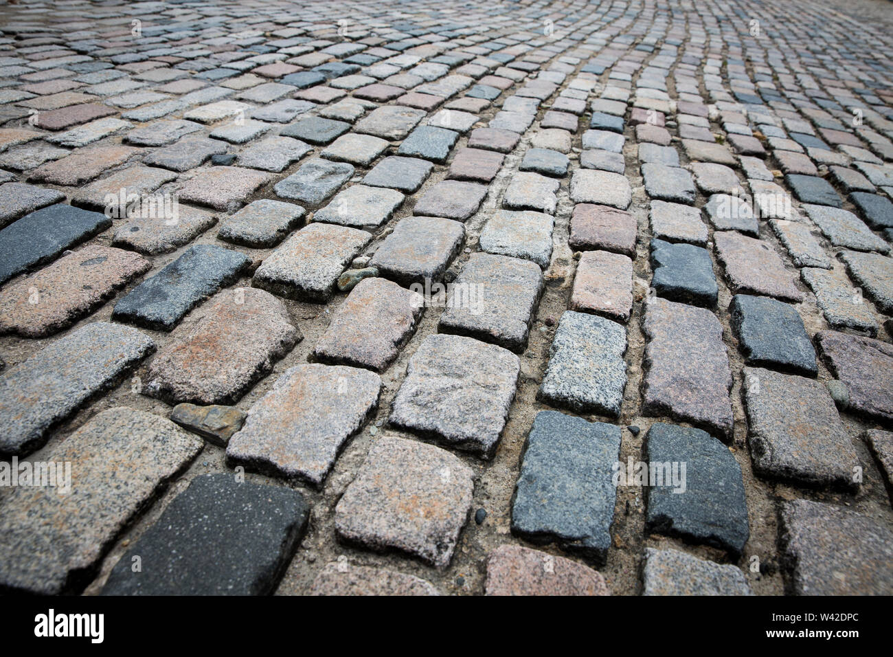 A full frame background image of rows of cobblestones stretching into ...