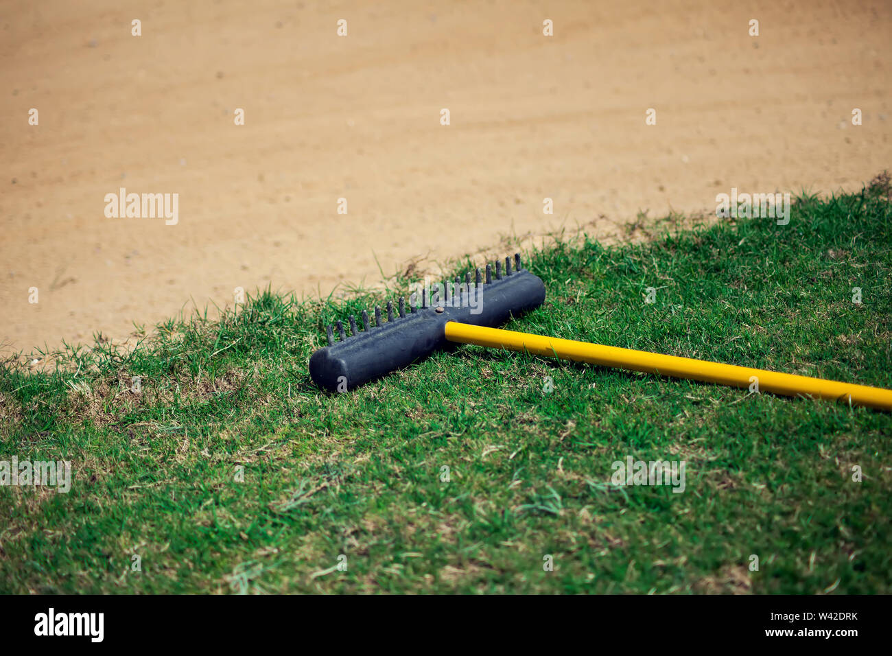 Sand rake equipment on the golf field. Sport and lifestyle concept ...