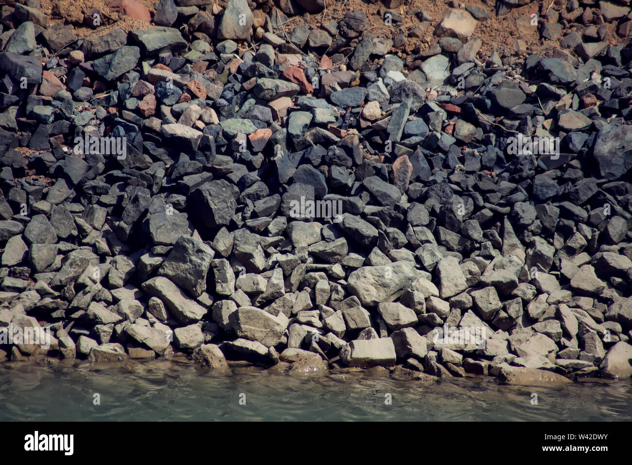 Dark rocks at the beach background. Stone texture Stock Photo - Alamy