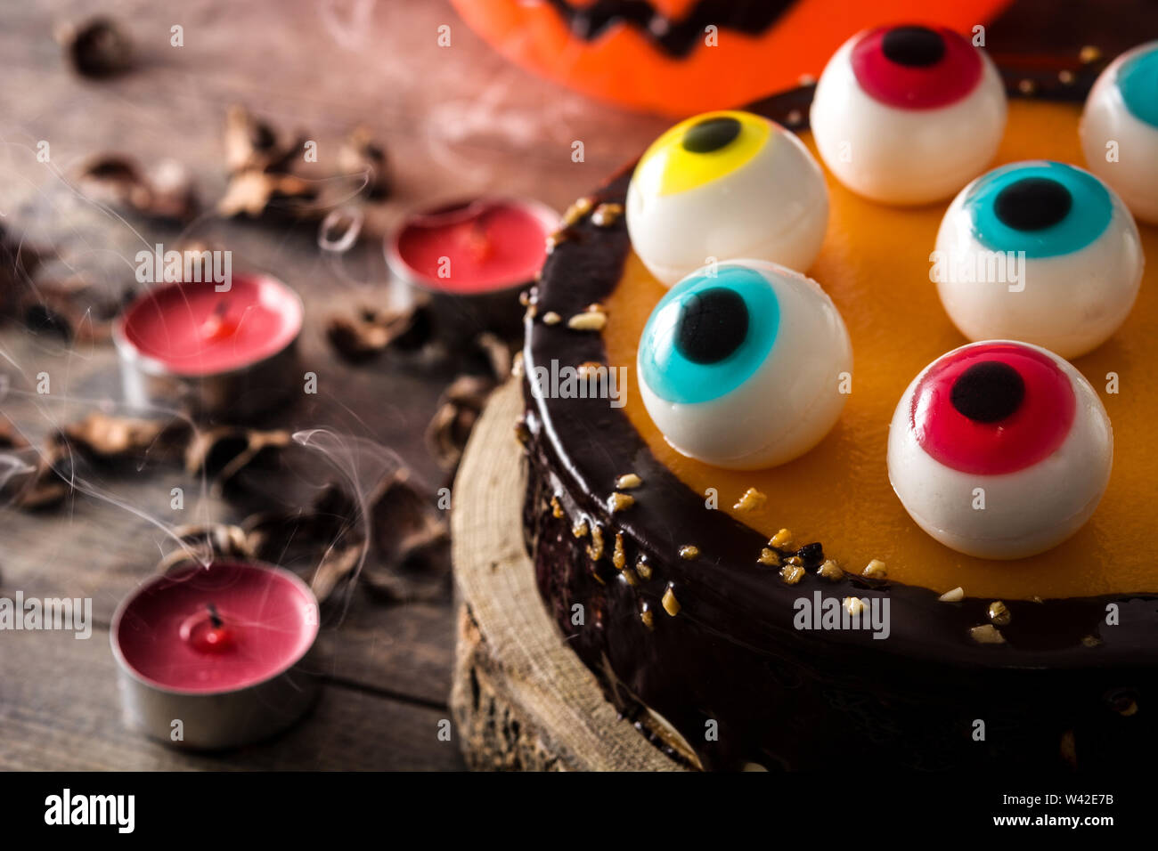 Halloween cake with candy eyes decoration on wooden table. Copyspace ...