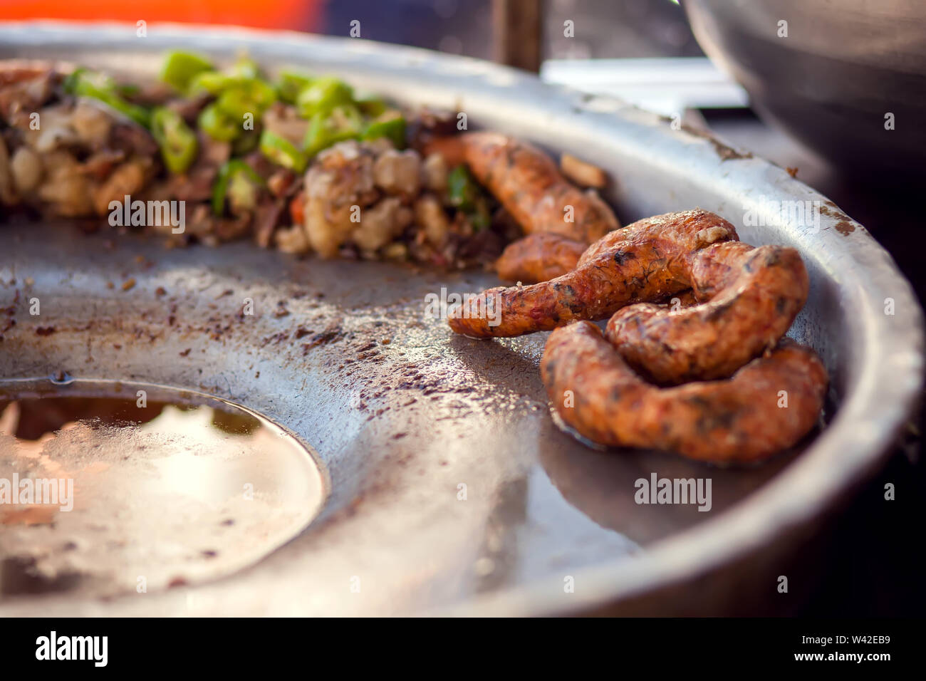 Rice-stuffed sausages called Mombar and vegetables on the plate ...