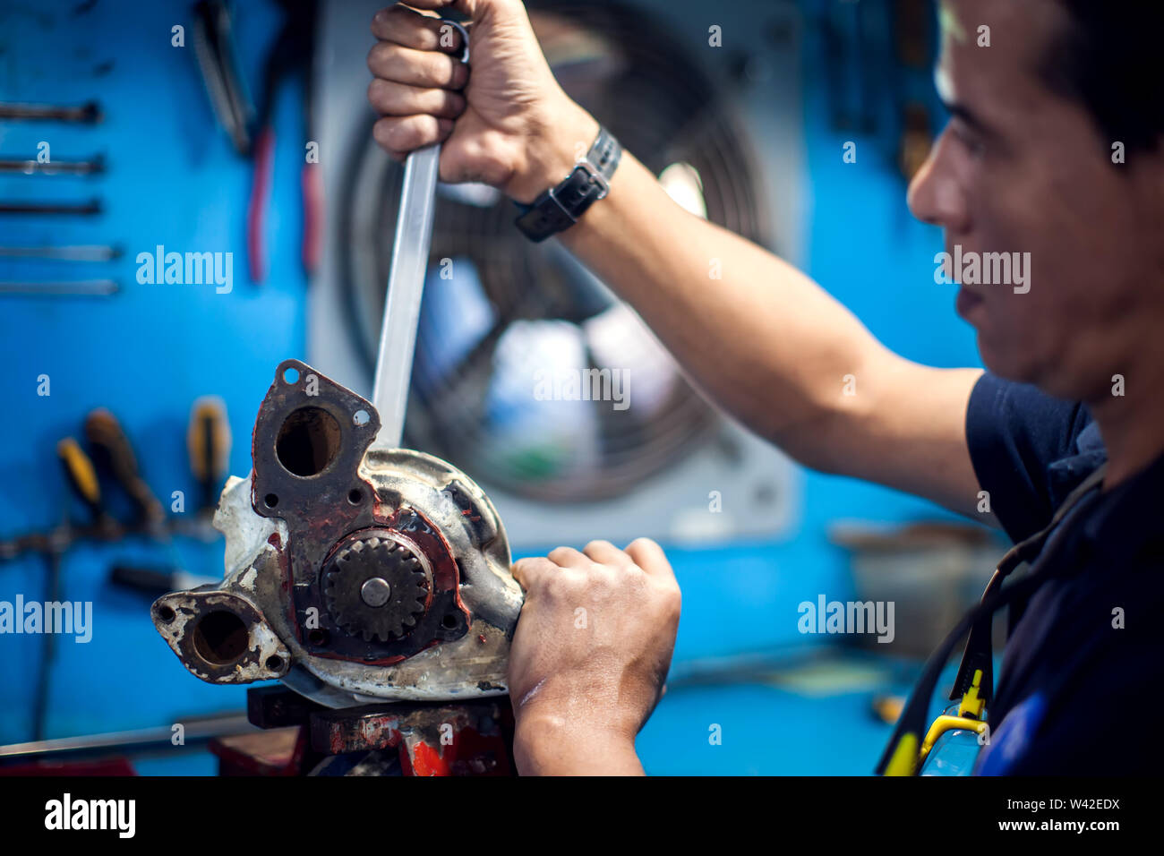 Man repairs part of engine with wrench. People, work concept Stock ...