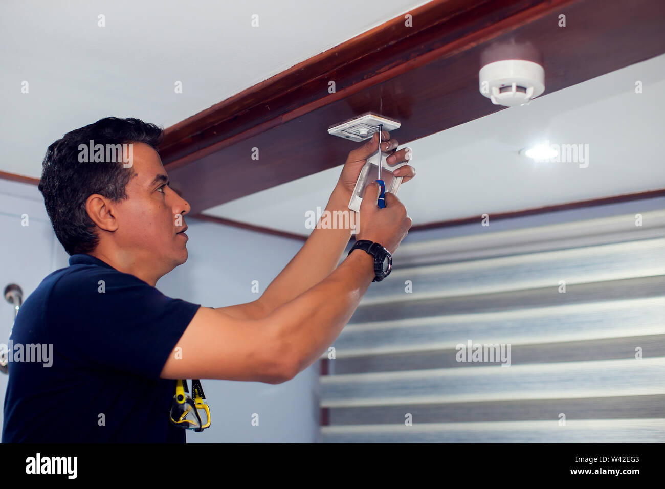 A portrait of a man doing electrical work during renovations Stock ...