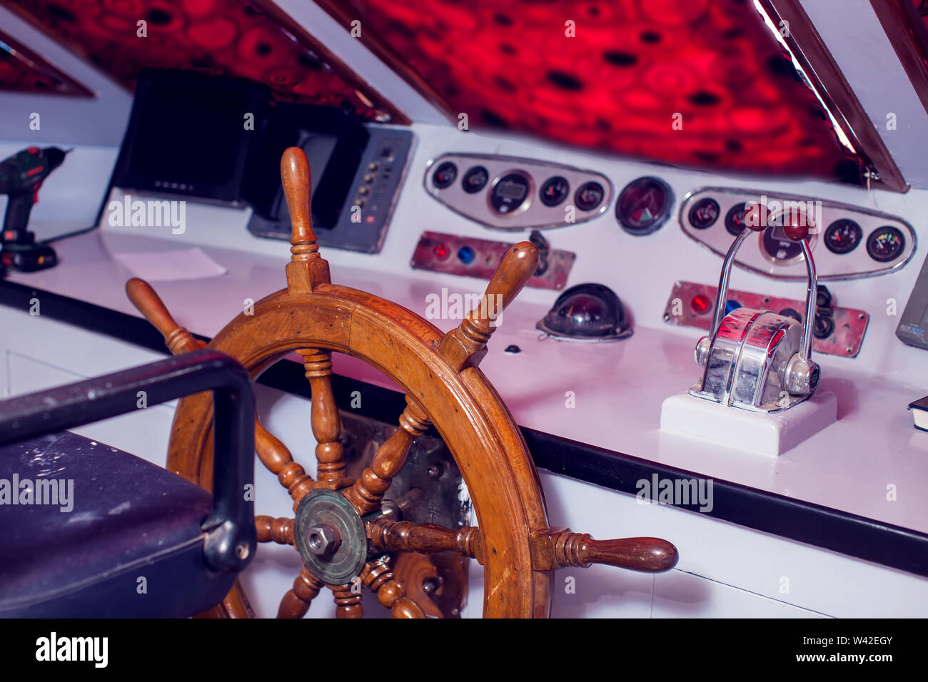 Wooden steering wheel and control panel on a yacht Stock Photo - Alamy