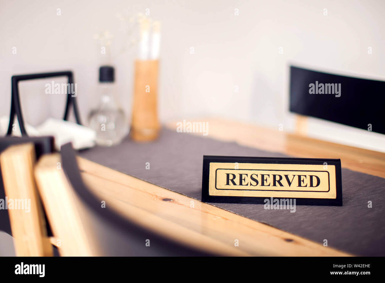 Reserved sign with capital letters on the dining table in restaurant ...