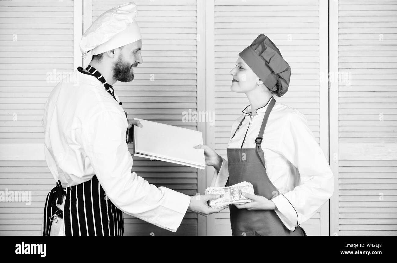 Cash in hand. Master cook and helper holding account book and cash ...