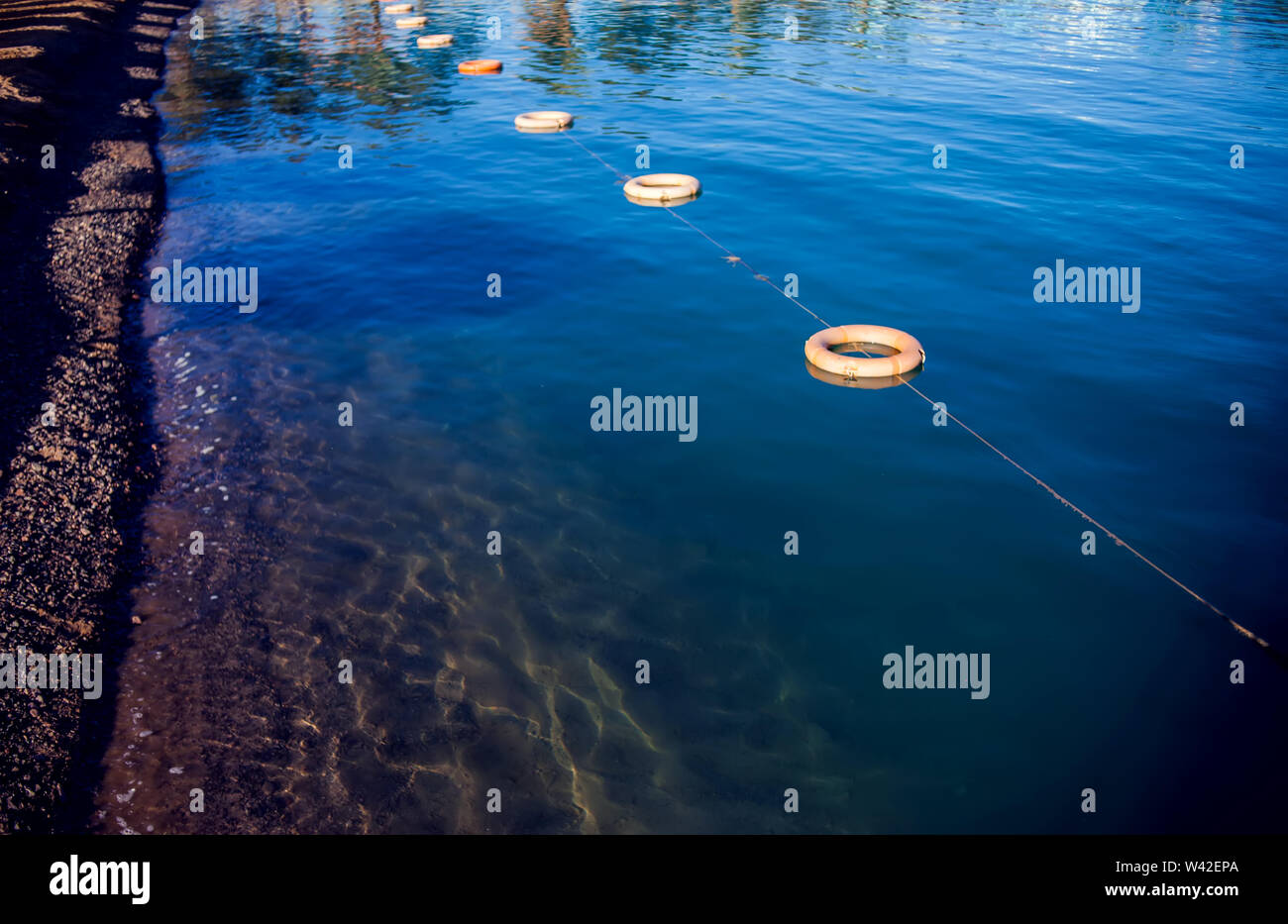 Protective buoys on sea surface. Fencing on water. Save zone for ...
