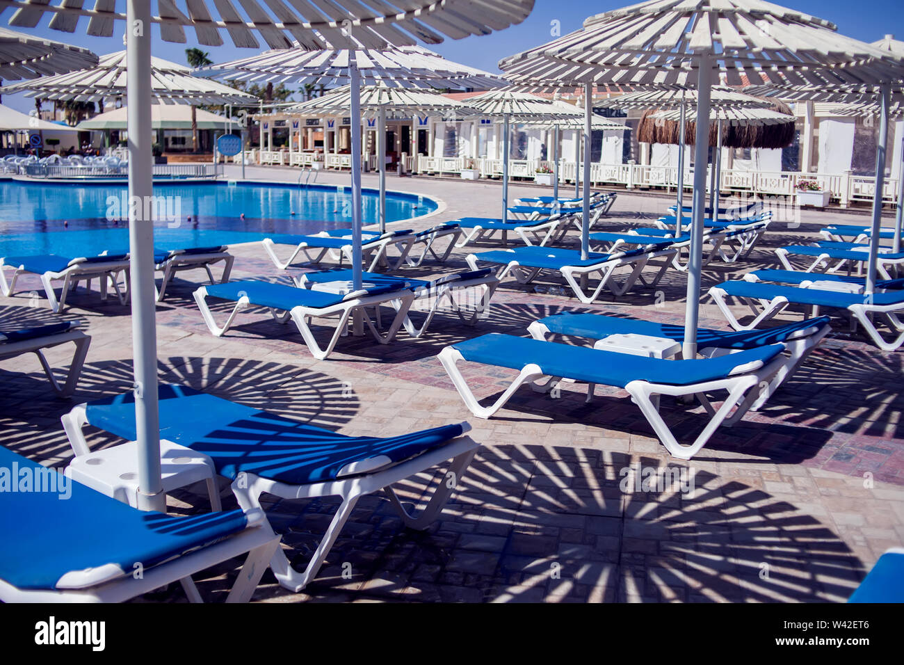 Beach chairs near swimming pool. Holiday and summer concept Stock Photo ...
