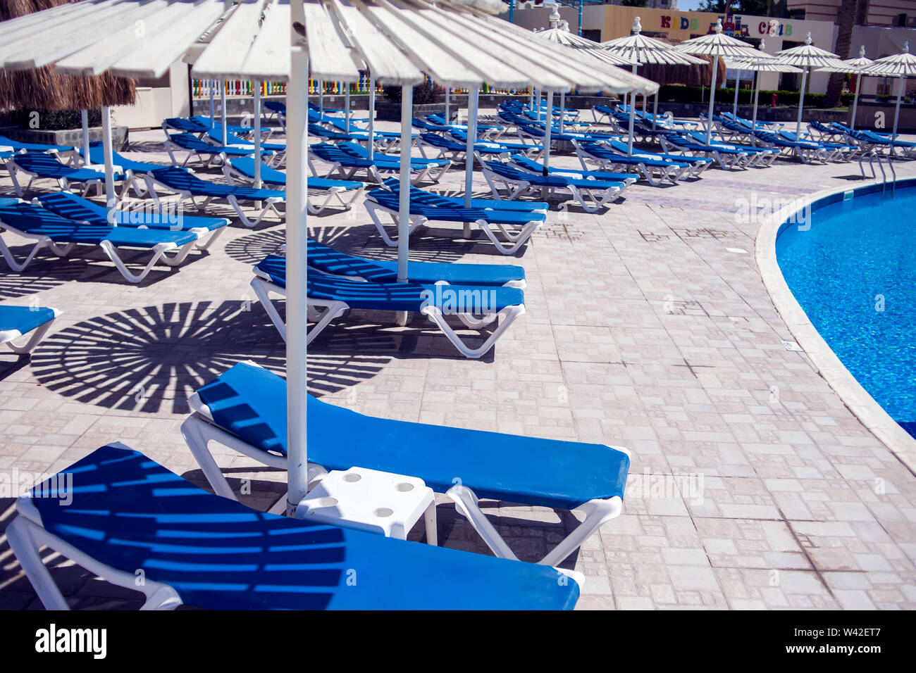 Beach chairs near swimming pool. Holiday and summer concept Stock Photo ...