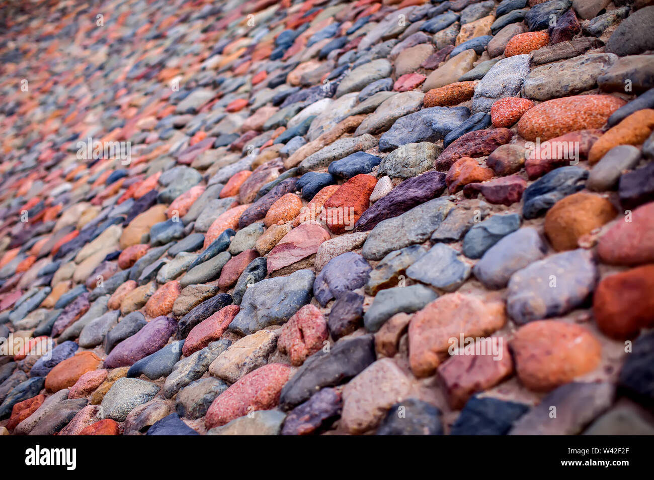 Pebble wall are made of stones of different sizes. Natural background ...