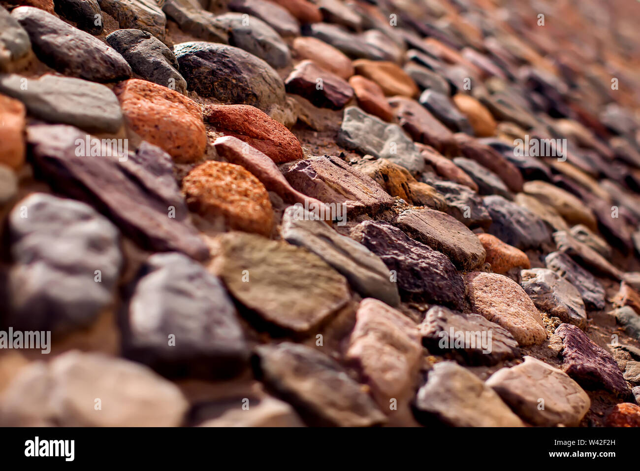 Pebble wall are made of stones of different sizes. Natural background ...