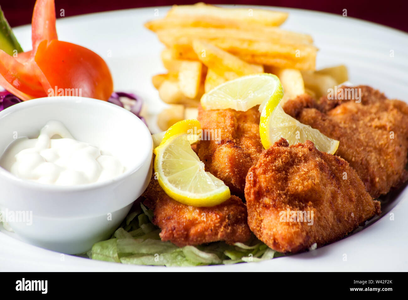 Battered chicken served with sauce in the cafe. Food concept Stock ...