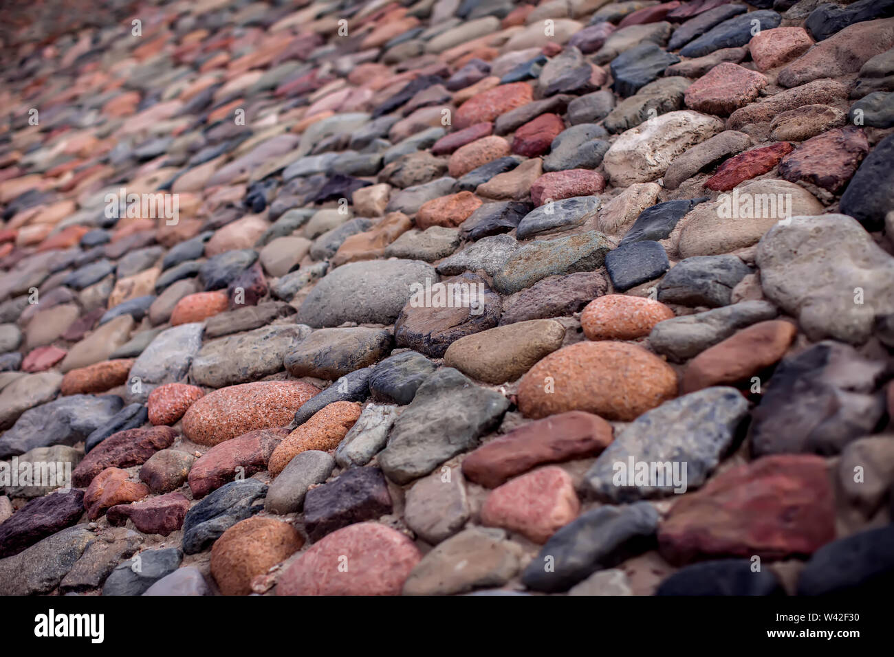 Pebble wall are made of stones of different sizes. Natural background ...