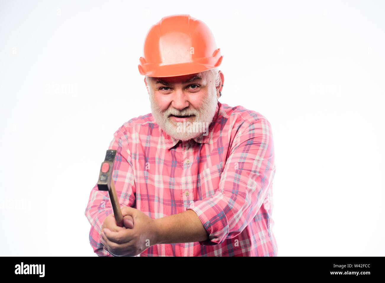 He loves his job. construction build. mature bearded man in hardhat ...