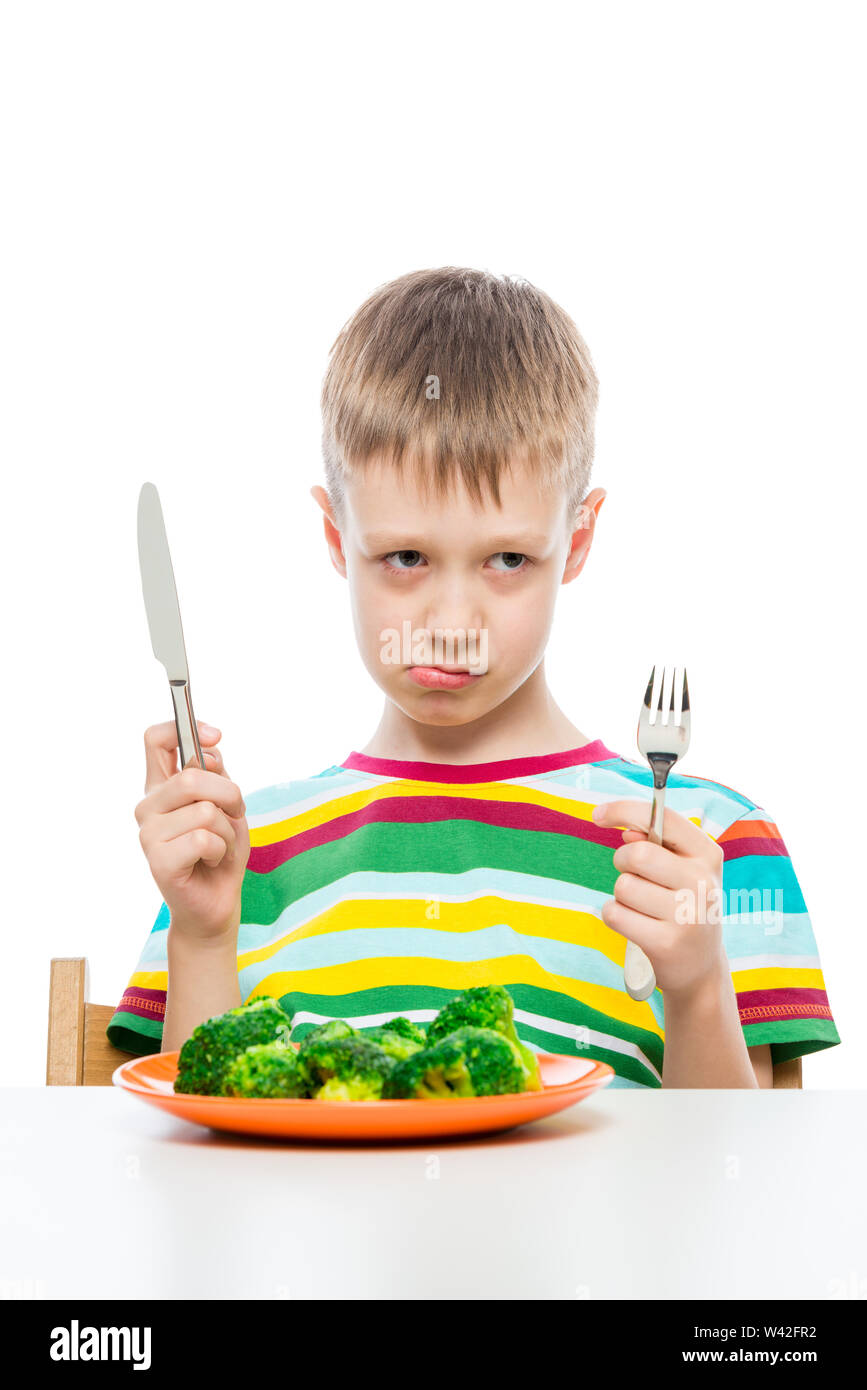 The boy with the unloved food broccoli on a white background Stock ...