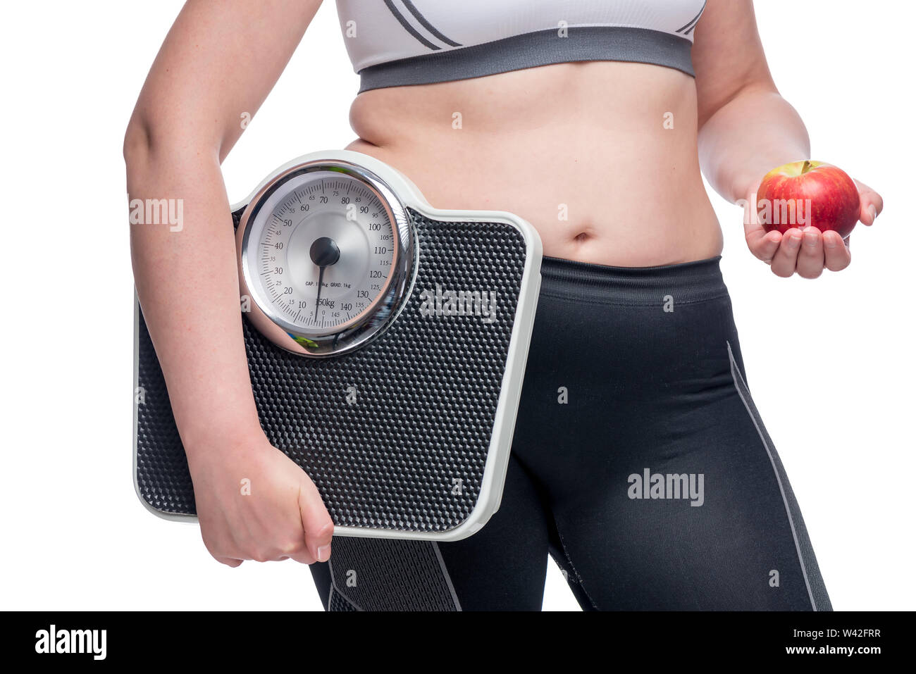 fat woman with weights and an apple makes a choice in favor of sports ...