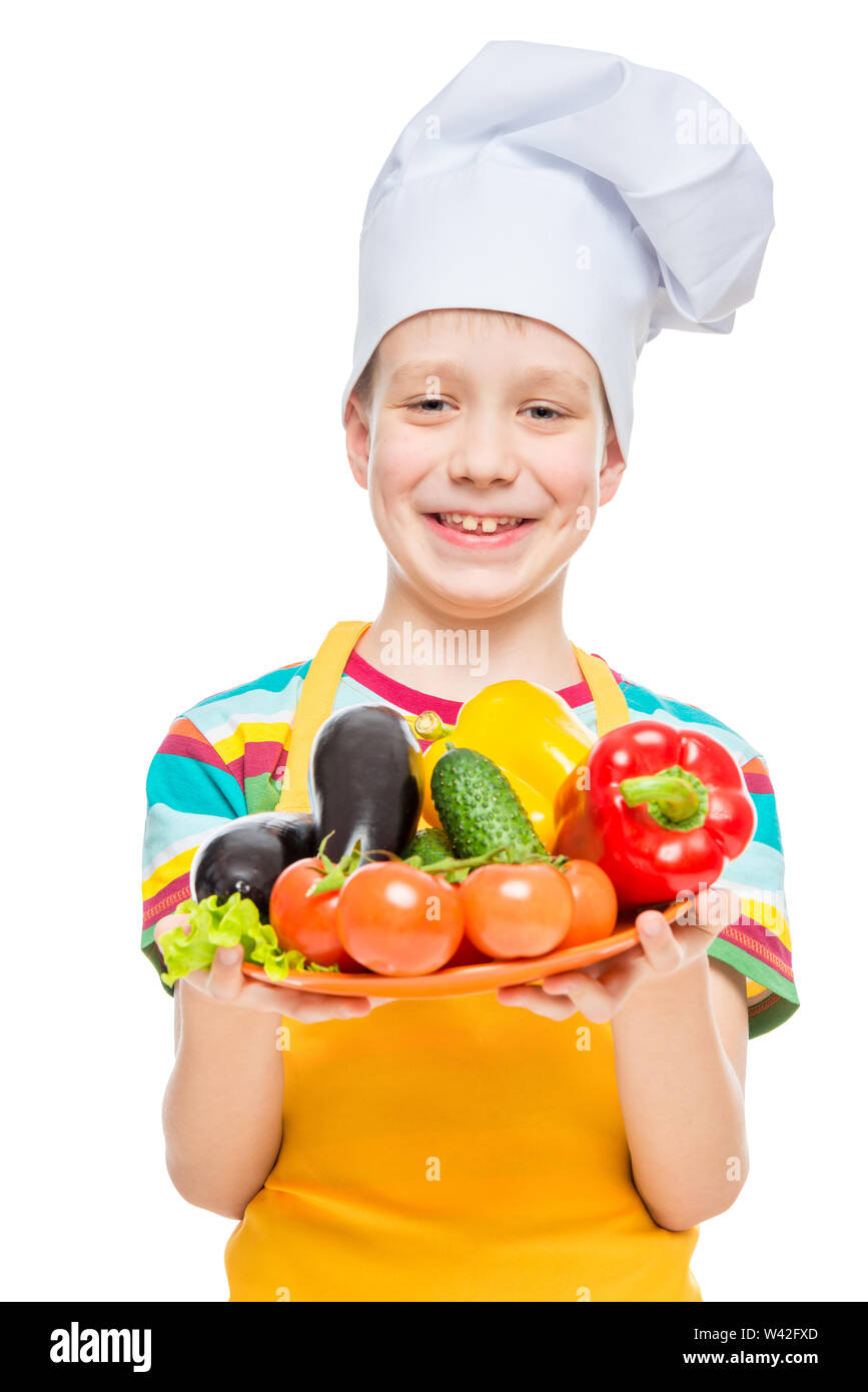 boy cook in a cap with a plate of ingredients - healthy vegetables on ...