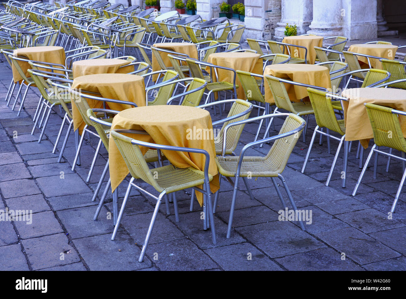 Yellow tables and chairs at an outdoor café in Venice, Italy Stock ...
