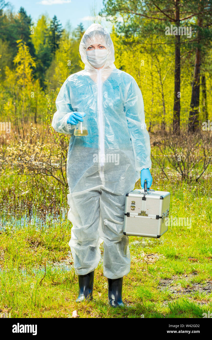 full-length portrait of an ecologist with a flask and water research ...