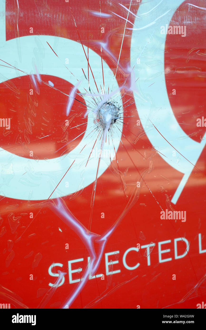 high street store window smashed by a vandal using a hammer commercial ...