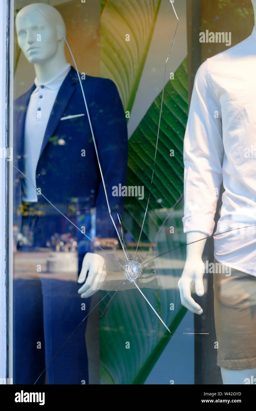 high street store window smashed by a vandal using a hammer commercial ...