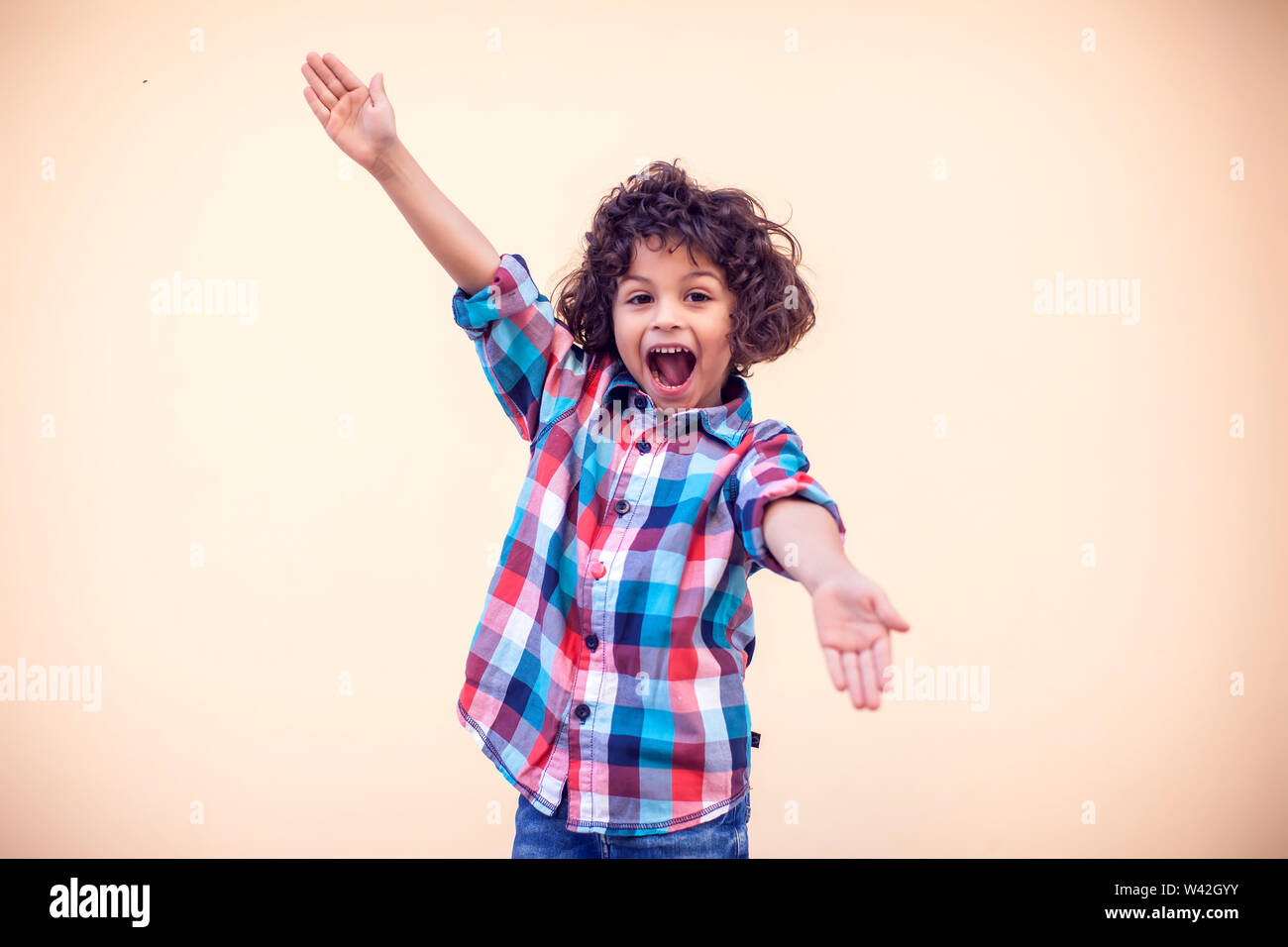Little boy kid shows hugs with open arms Stock Photo - Alamy