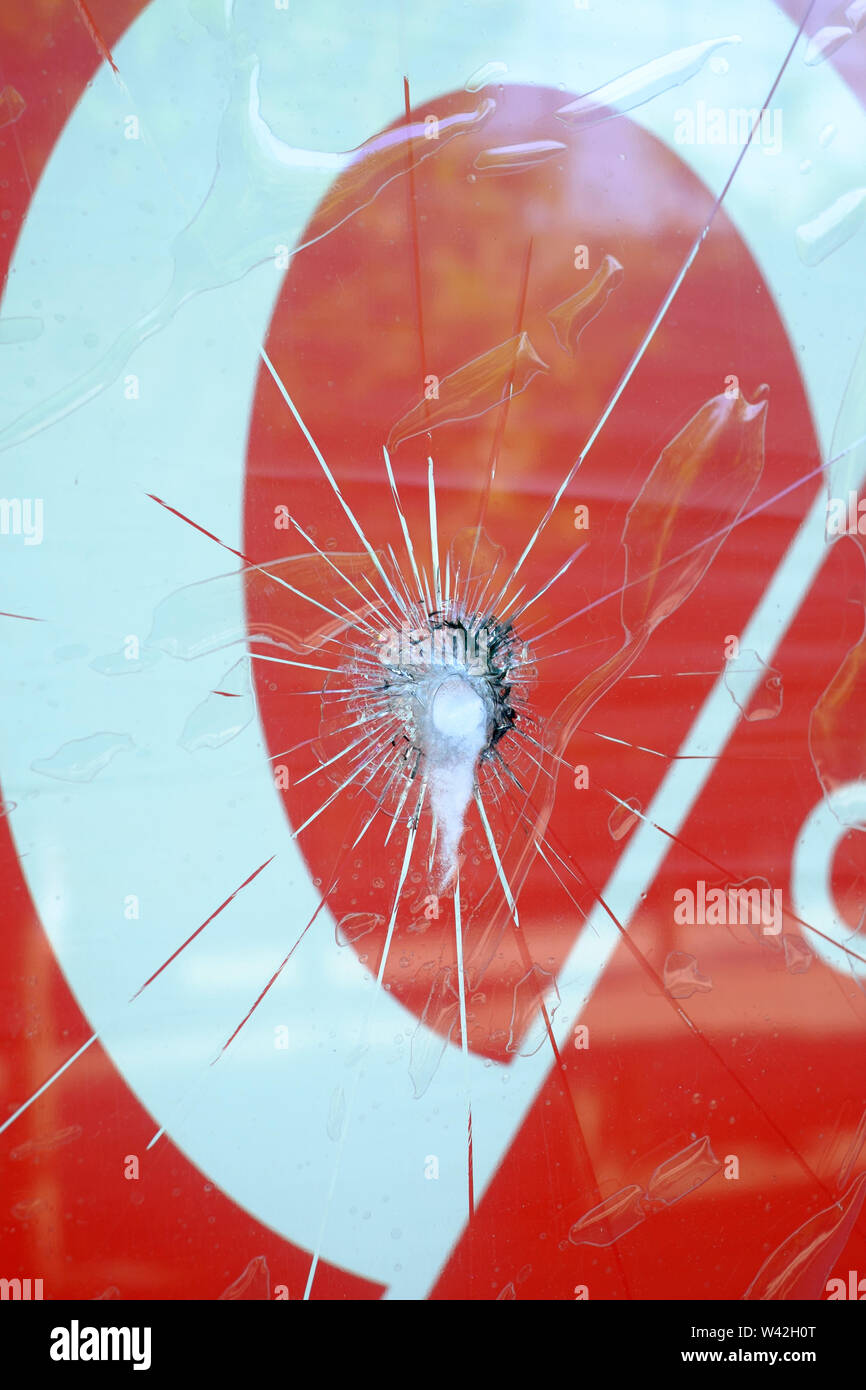 high street store window smashed by a vandal using a hammer commercial ...