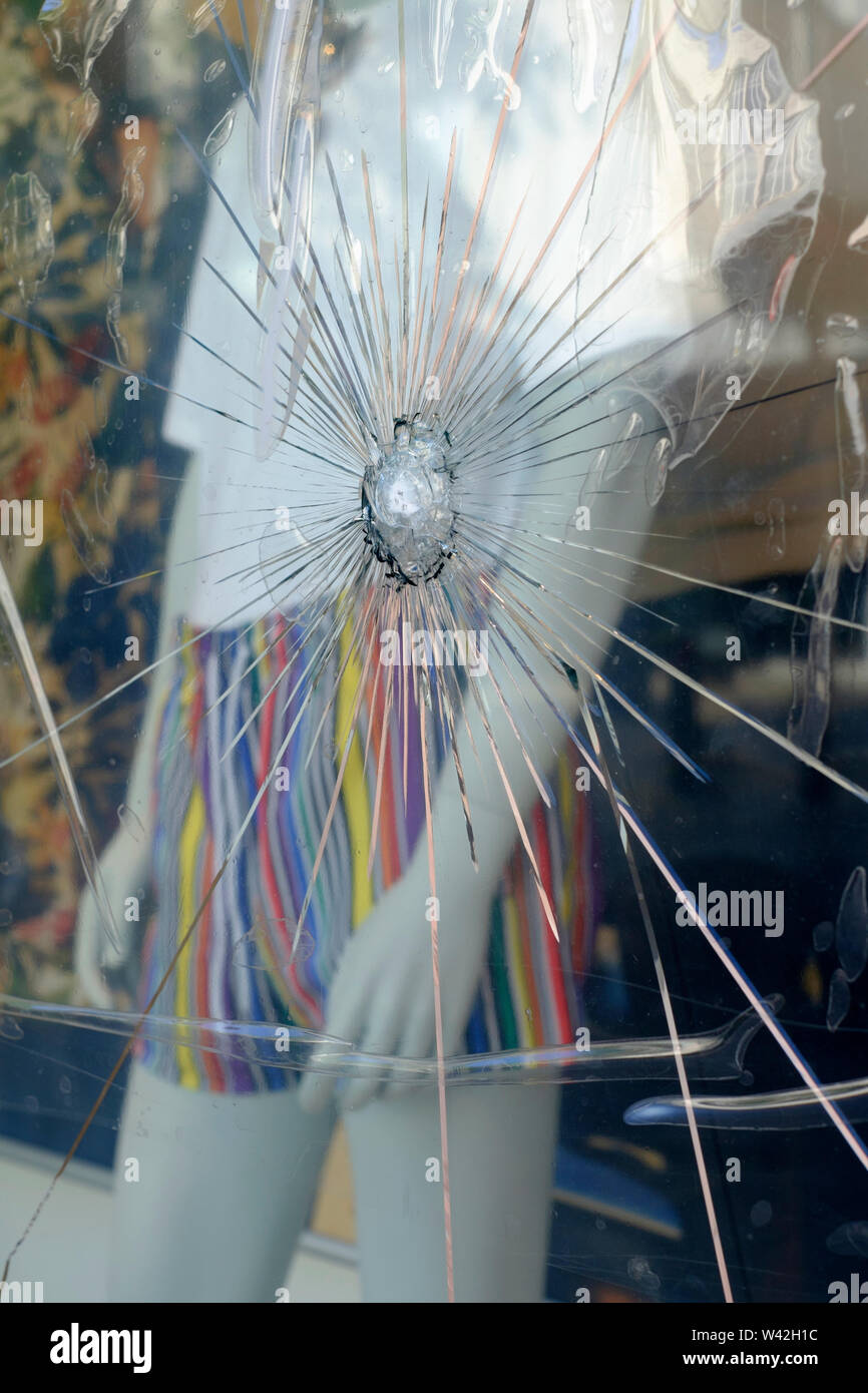 high street store window smashed by a vandal using a hammer commercial ...
