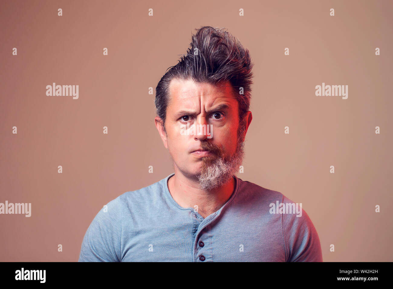 A portrait of man with half beard and hair on brown background Stock ...