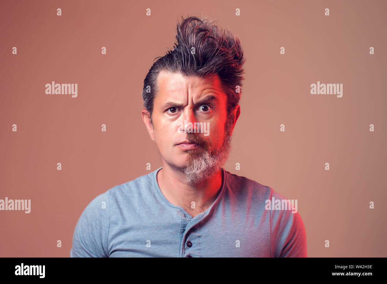 A portrait of man with half beard and hair on brown background Stock ...