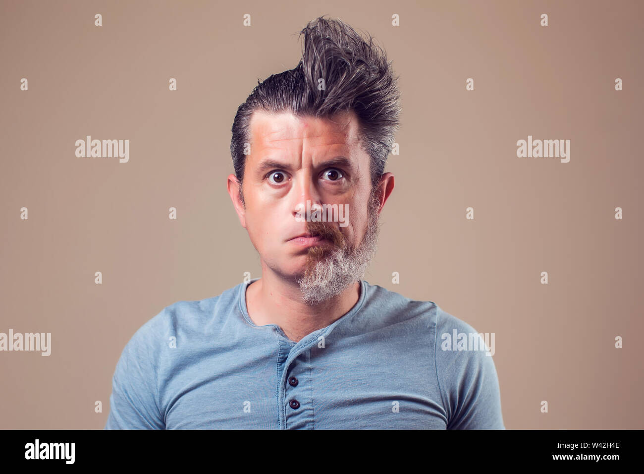 A portrait of man with half beard and hair on brown background Stock ...