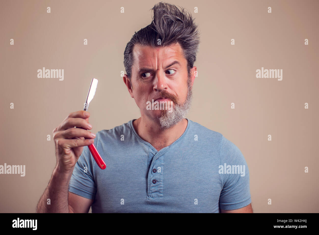 A portrait of man with half beard and hair on brown background Stock ...