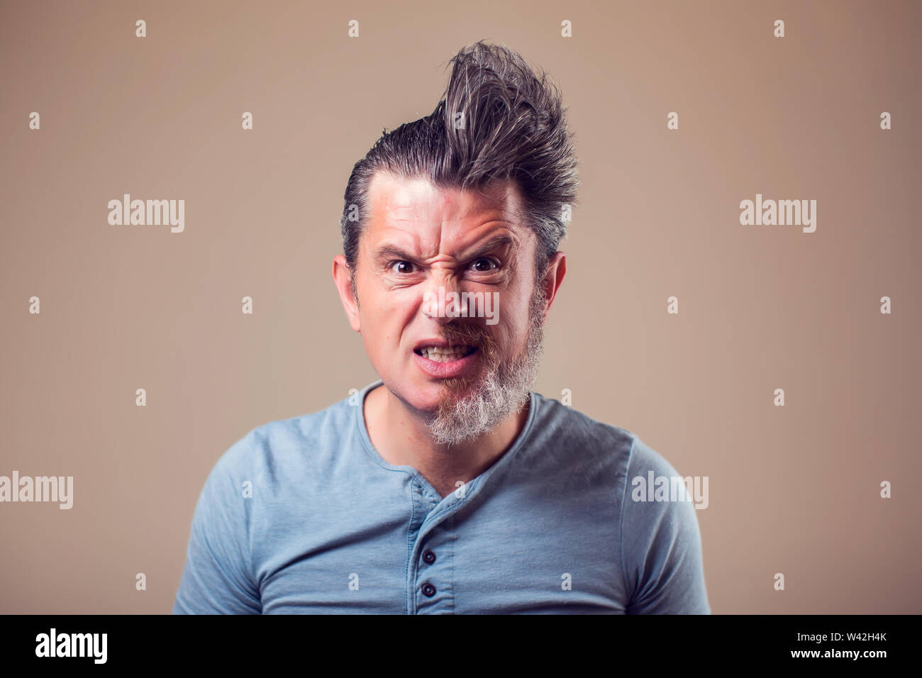 A portrait of man with half beard and hair on brown background Stock ...