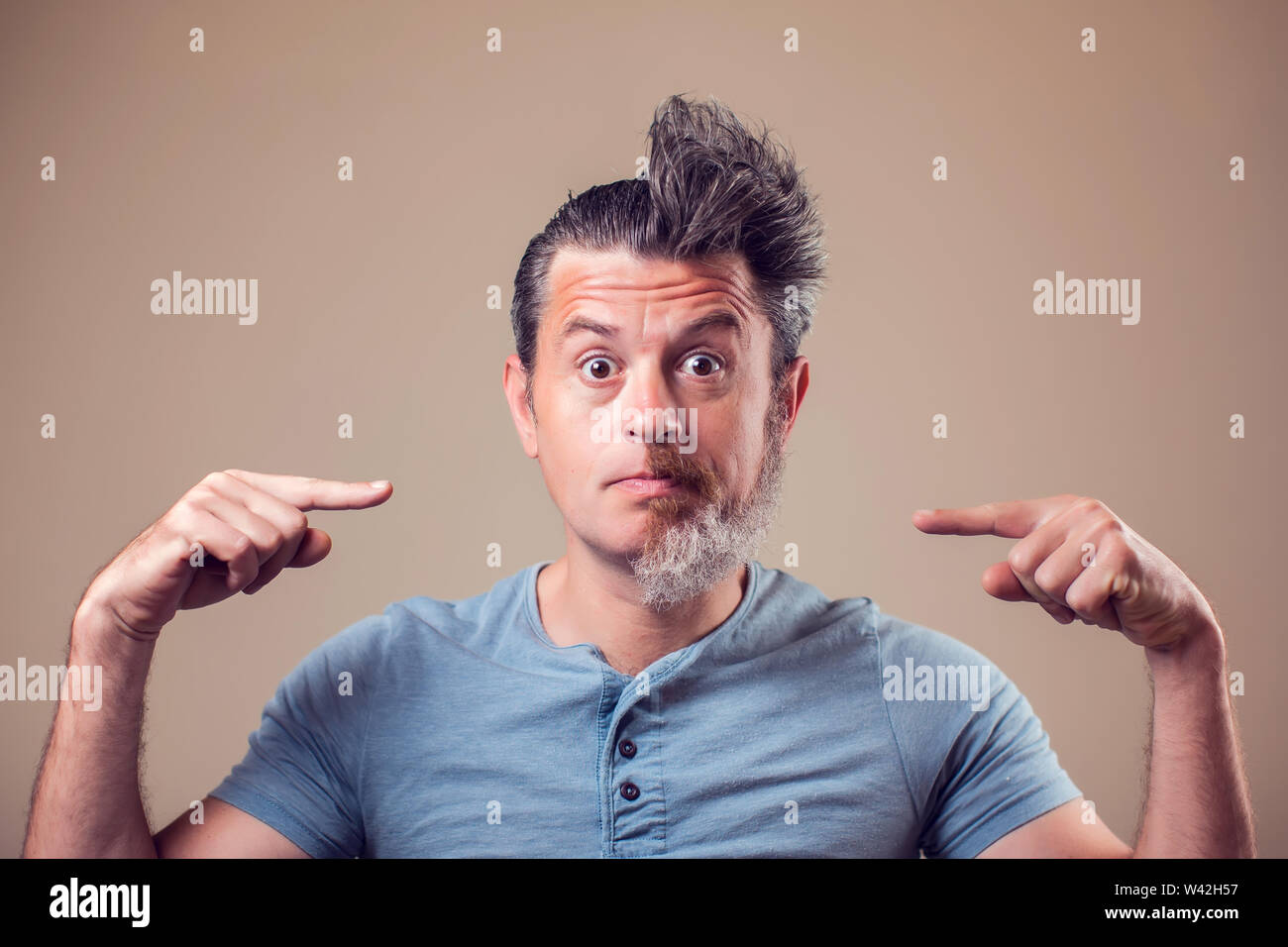 A portrait of man with half beard and hair on brown background Stock ...