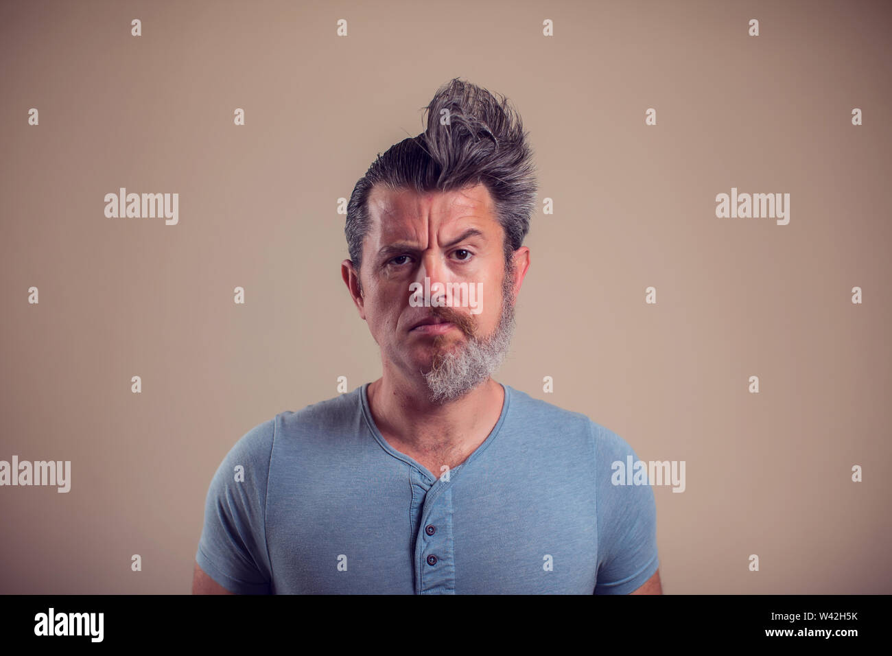 A portrait of man with half beard and hair on brown background Stock ...