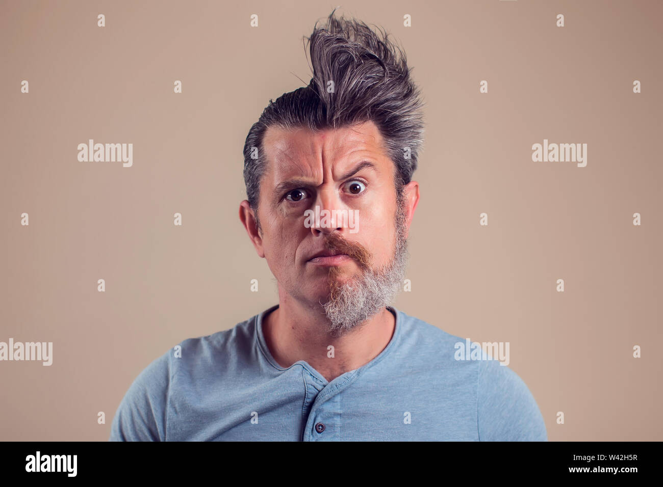 A portrait of man with half beard and hair on brown background Stock ...