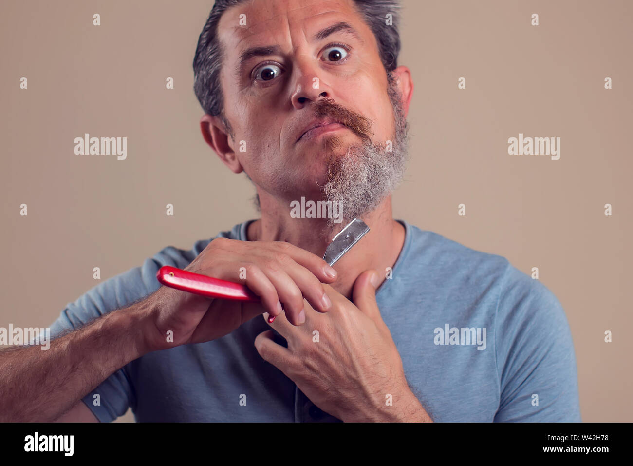 A portrait of man with half beard and hair on brown background Stock ...