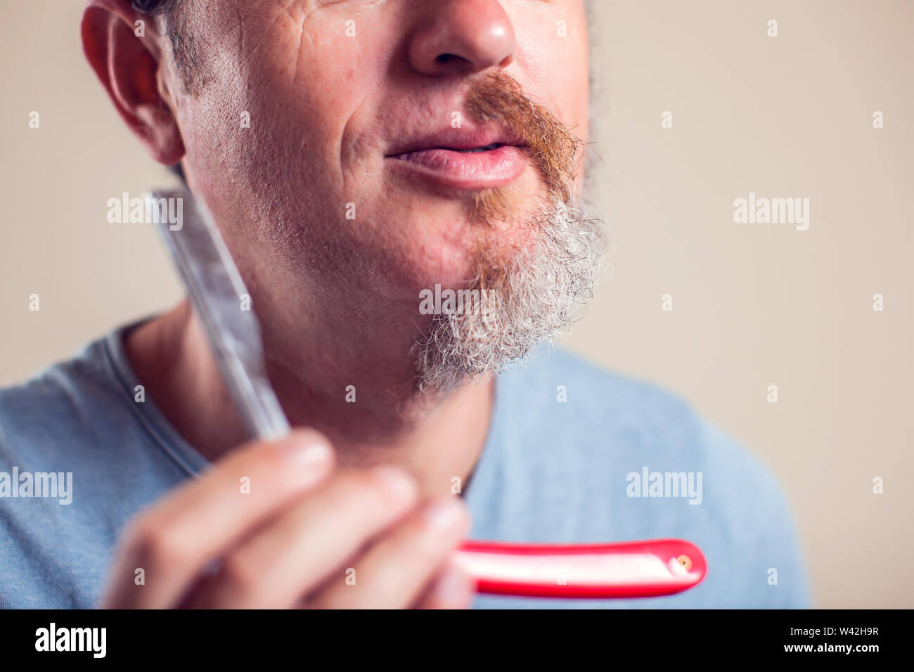 A portrait of man with half beard and hair on brown background Stock ...