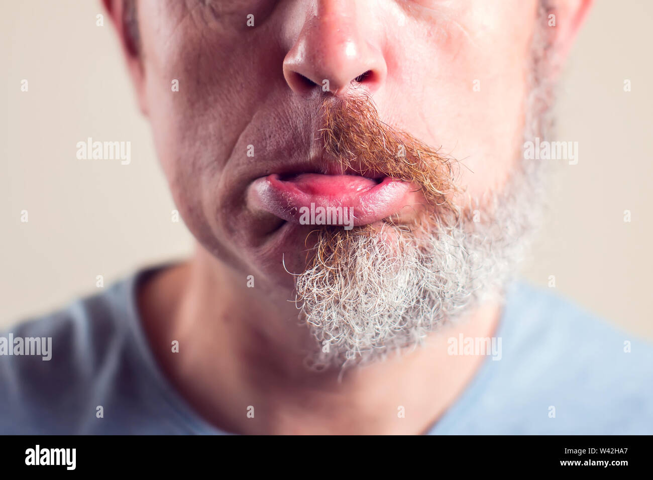 A portrait of man with half beard and hair on brown background Stock ...