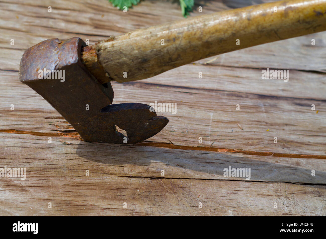 Vintage ax stuck in wood casting shadow on wood Stock Photo - Alamy