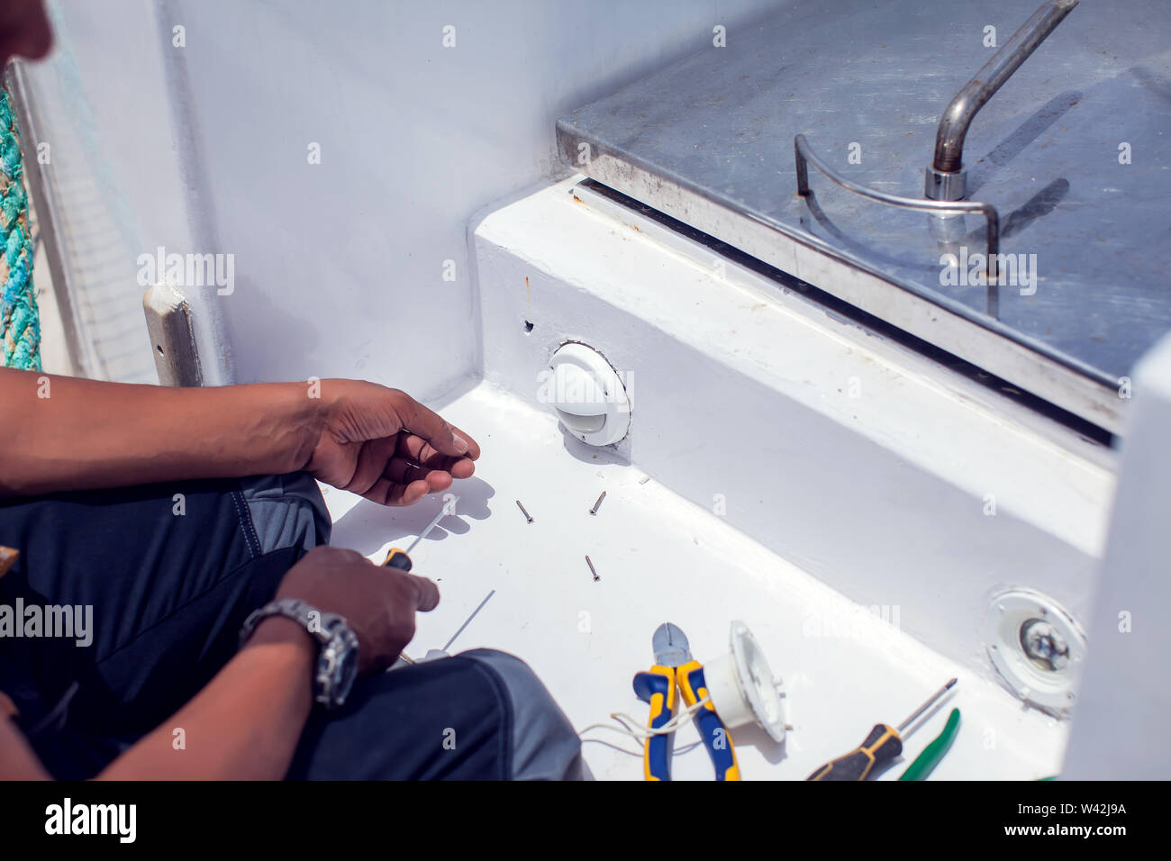 A man worker fix socket in the wall Stock Photo - Alamy