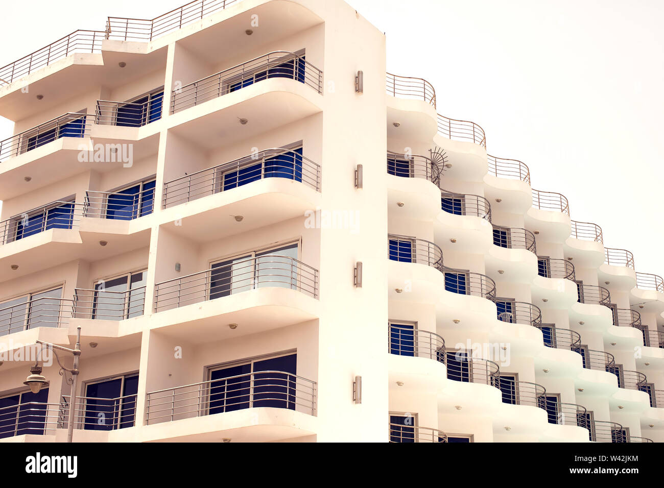 White color building with balcony. Architecture and design concept ...