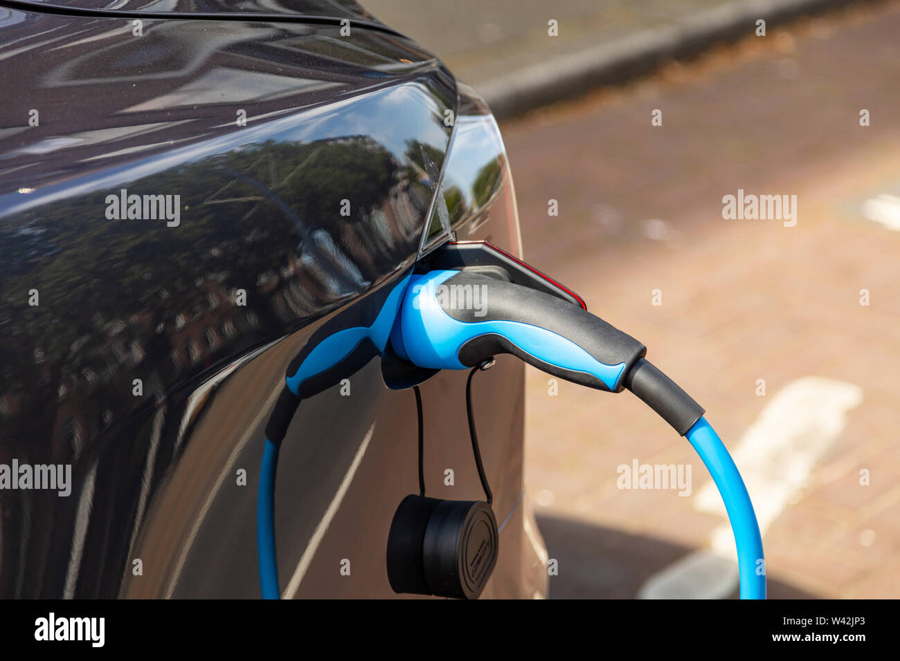 Charging the electric vehicle battery . EV fuel Plug in hybrid car ...