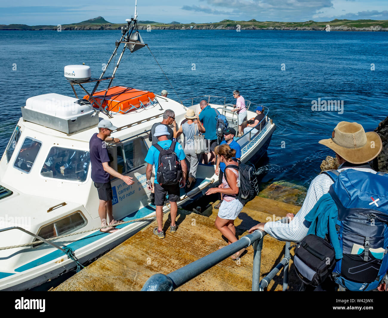 A group of tourists boarding the Gower Ranger boat on RSPB Ramsey ...
