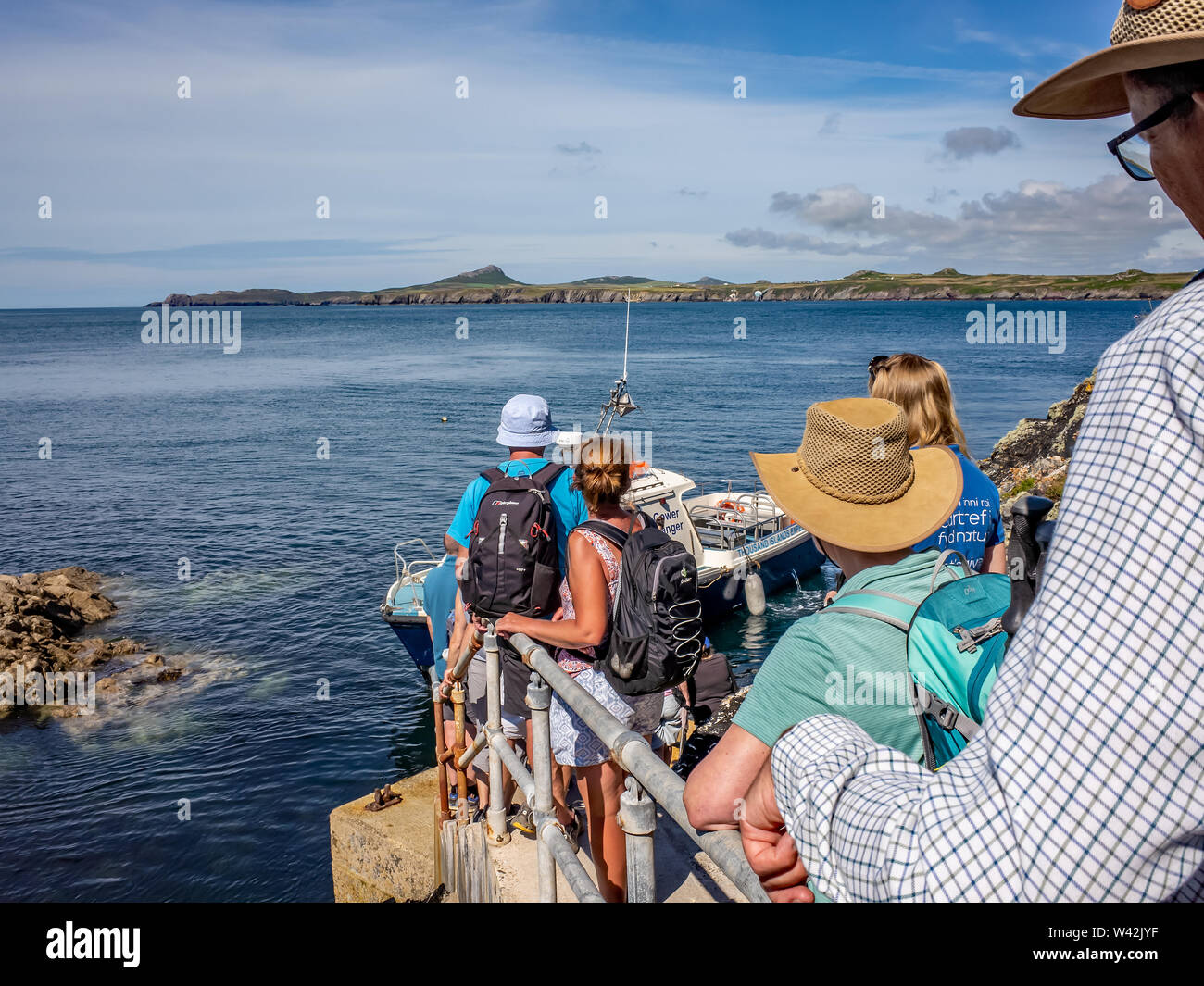 A group of tourists boarding the Gower Ranger boat on RSPB Ramsey ...