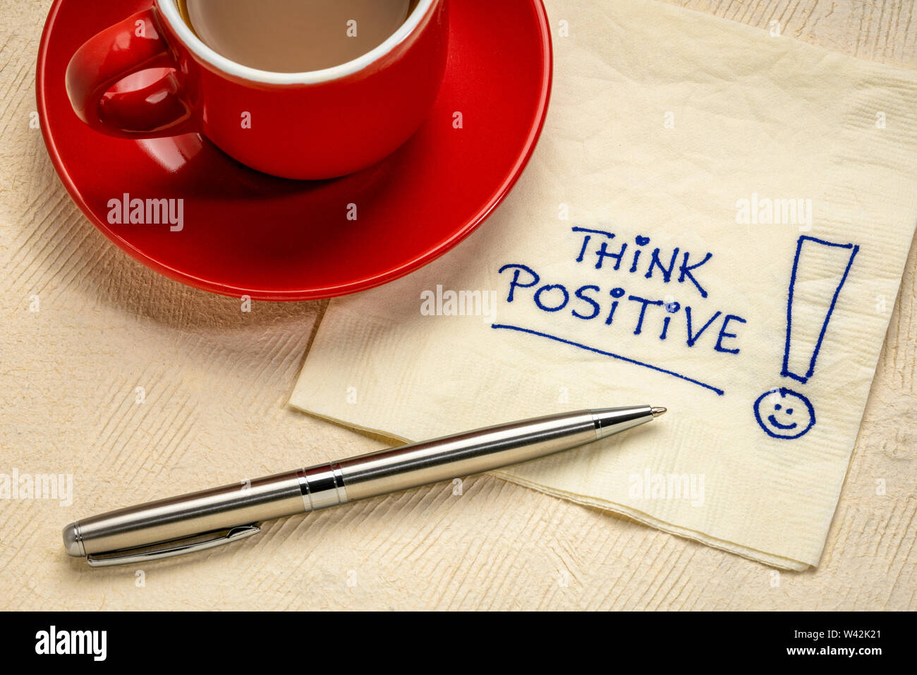 think positive motivational reminder - handwriting on a napkin with a ...