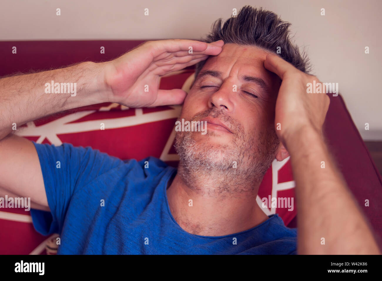 Man feels strong headache at home. People, healthcare and medicine ...